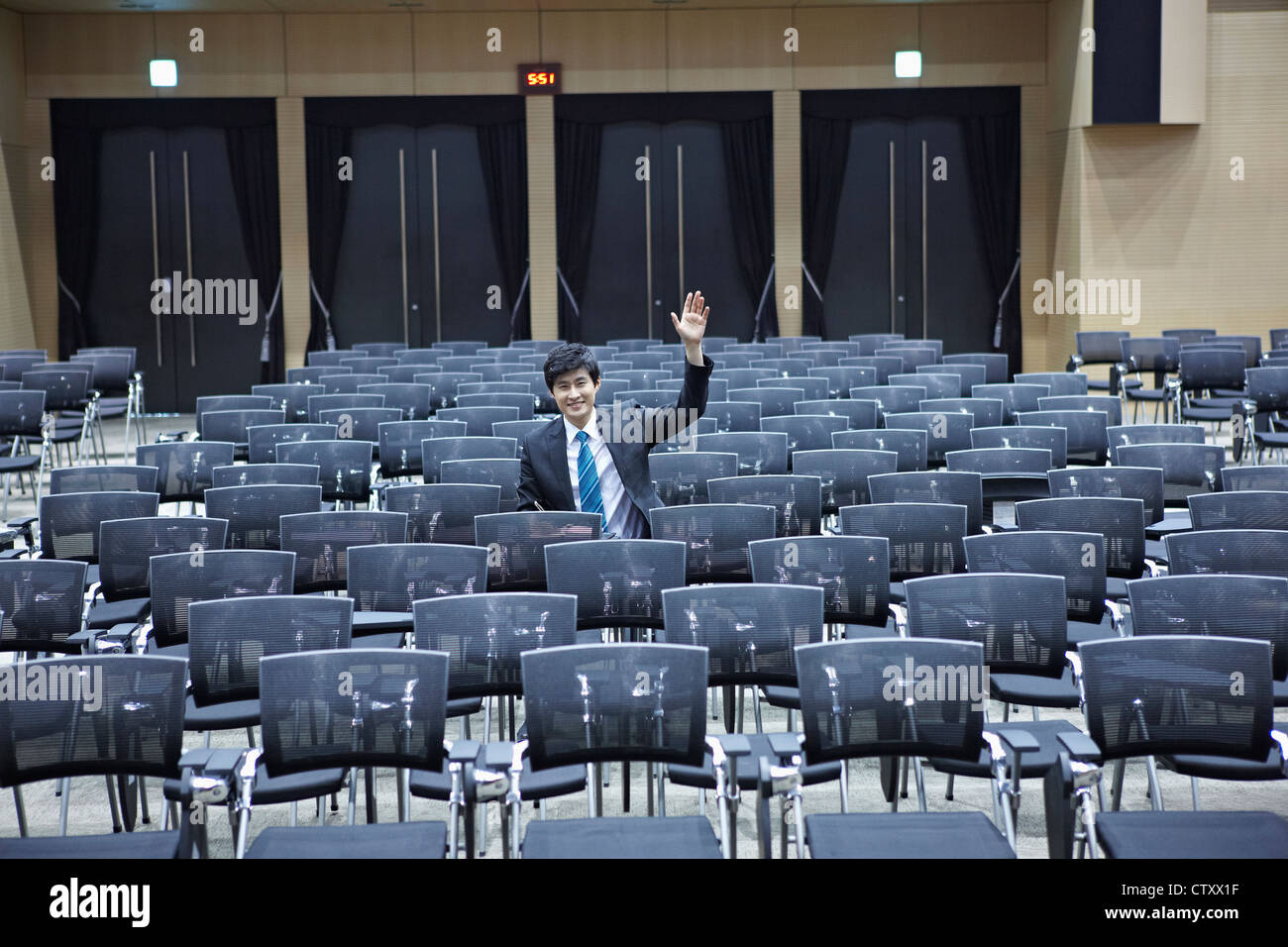 A businessman asking the question in the auditorium Stock Photo - Alamy