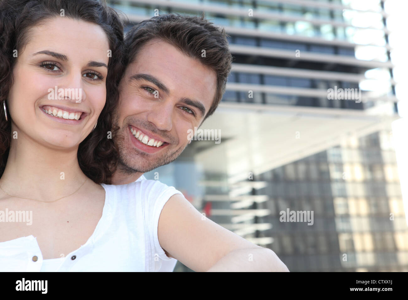 Couple in front of modern building Stock Photo - Alamy