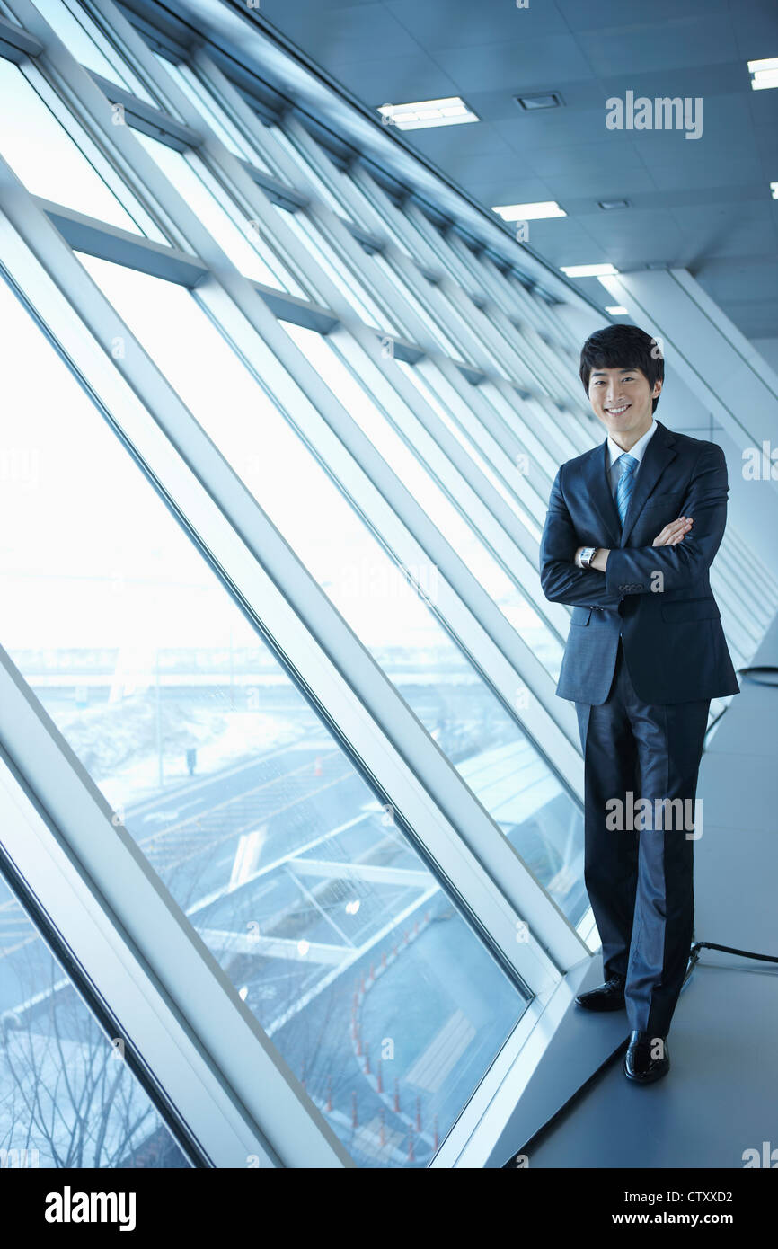 A businessman standing by the window Stock Photo - Alamy