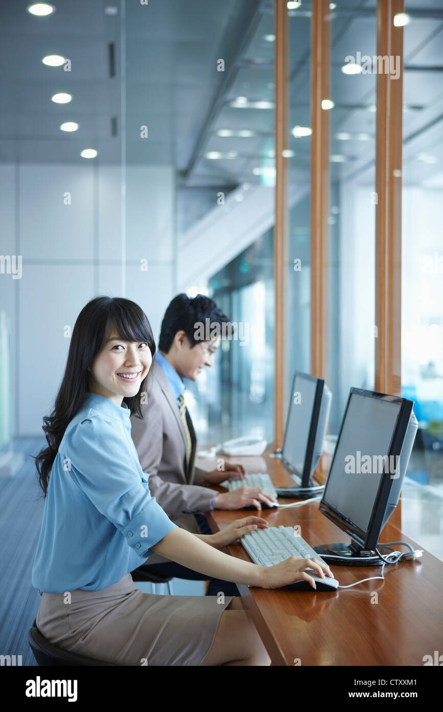 Businessmen using computer in the lounge Stock Photo - Alamy