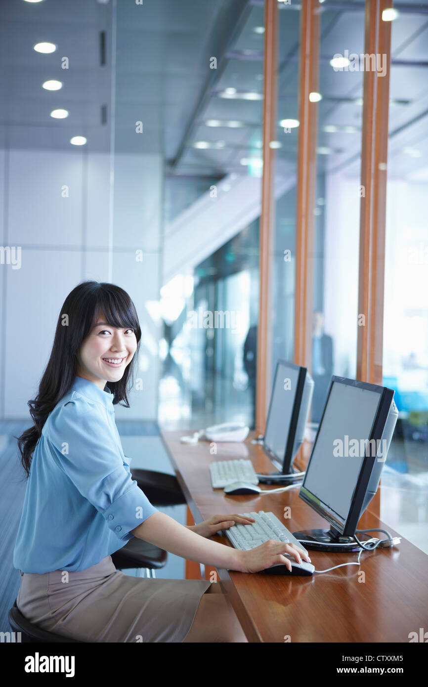 A business woman using computer in the lounge Stock Photo - Alamy