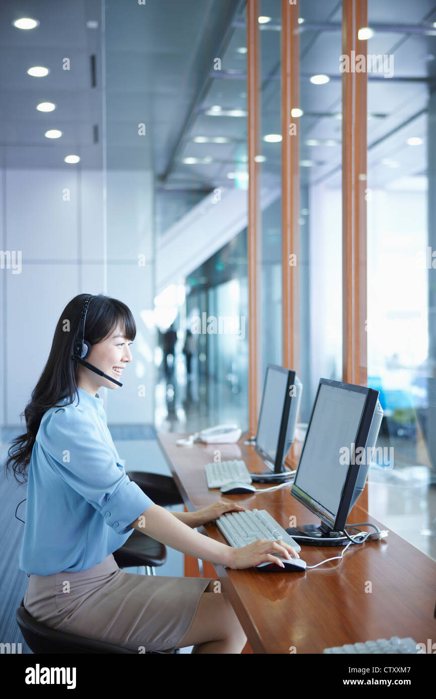 A business woman putting on the headset Stock Photo - Alamy