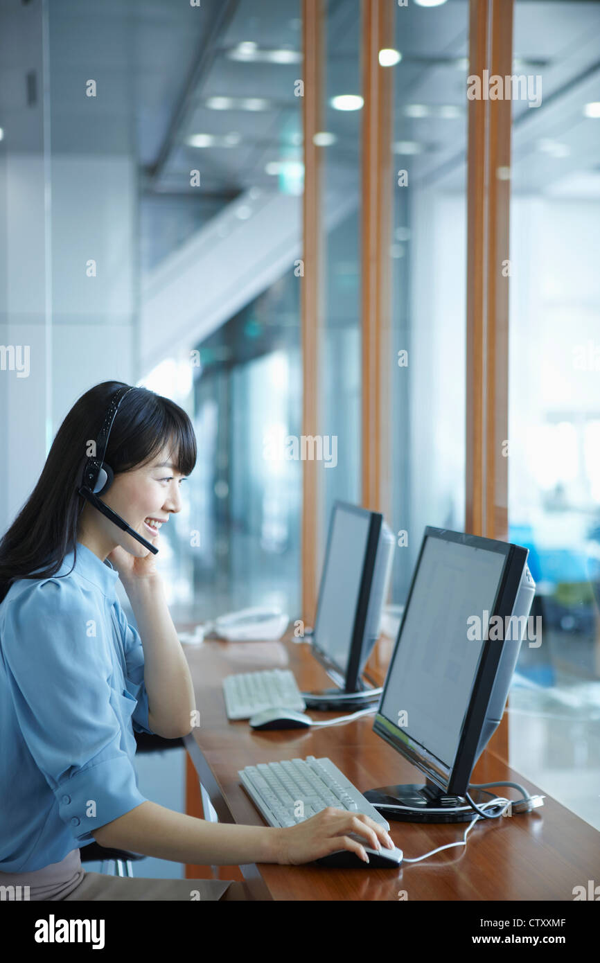 A business woman putting on the headset Stock Photo - Alamy
