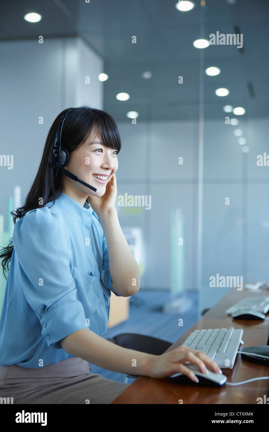 A business woman putting on the headset Stock Photo - Alamy