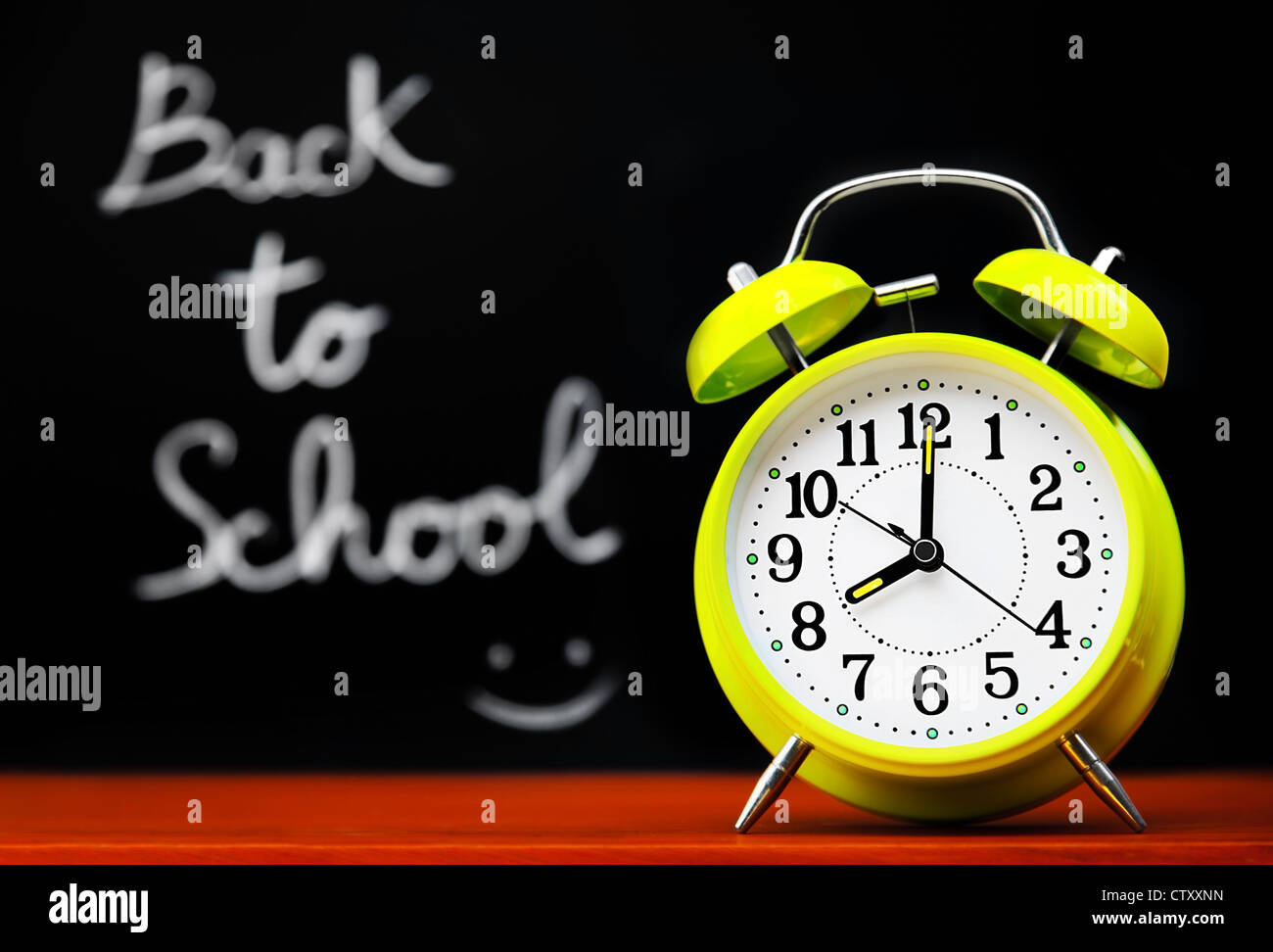 Back to school conceptual image with alarm clock & chalkboard in the ...