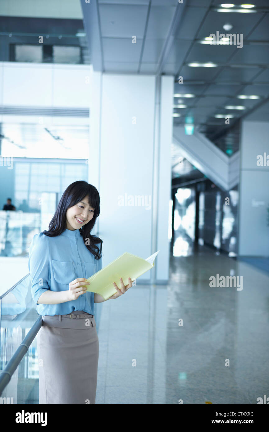 A business woman looking over the document Stock Photo - Alamy