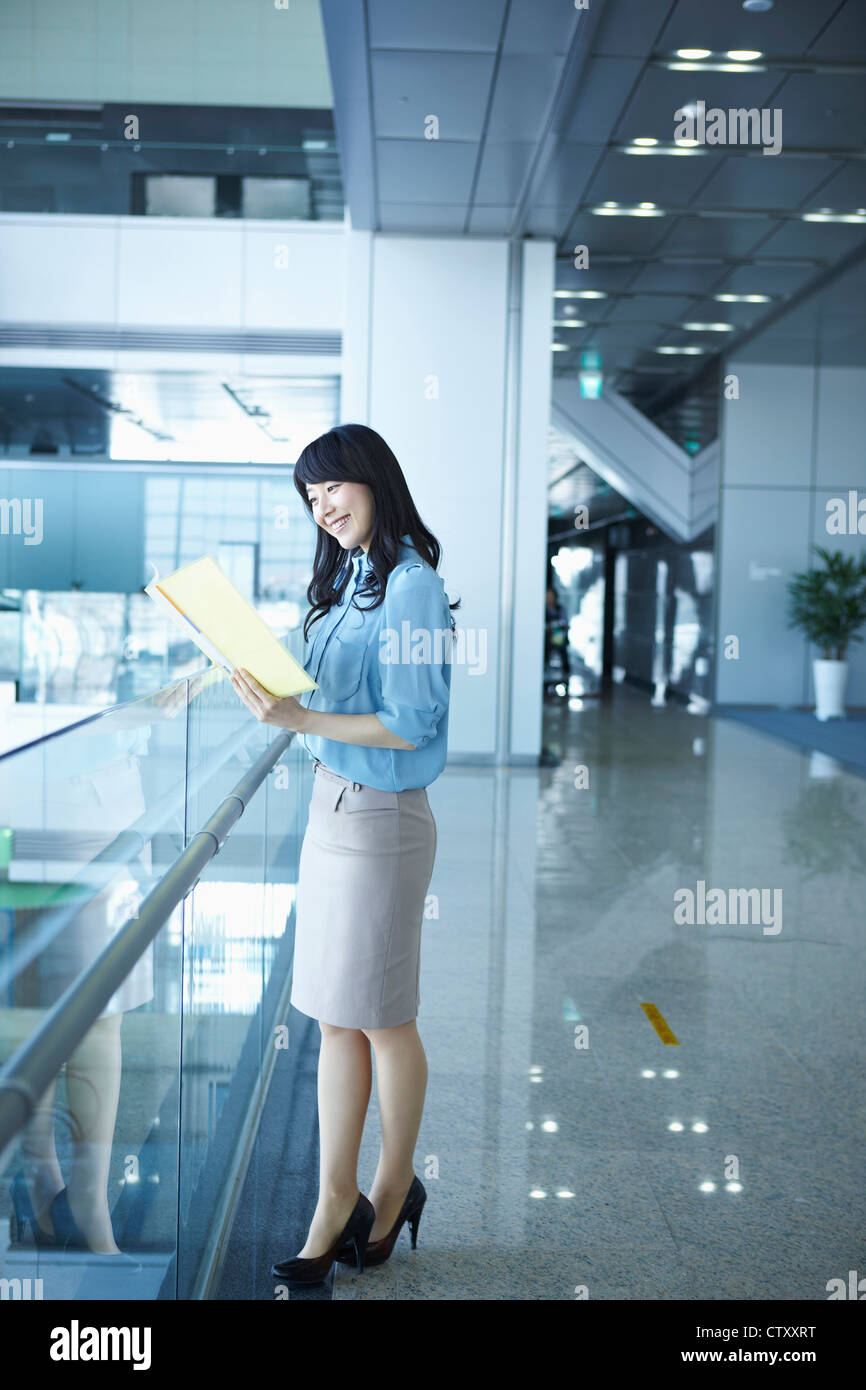 A business woman looking over the document Stock Photo - Alamy