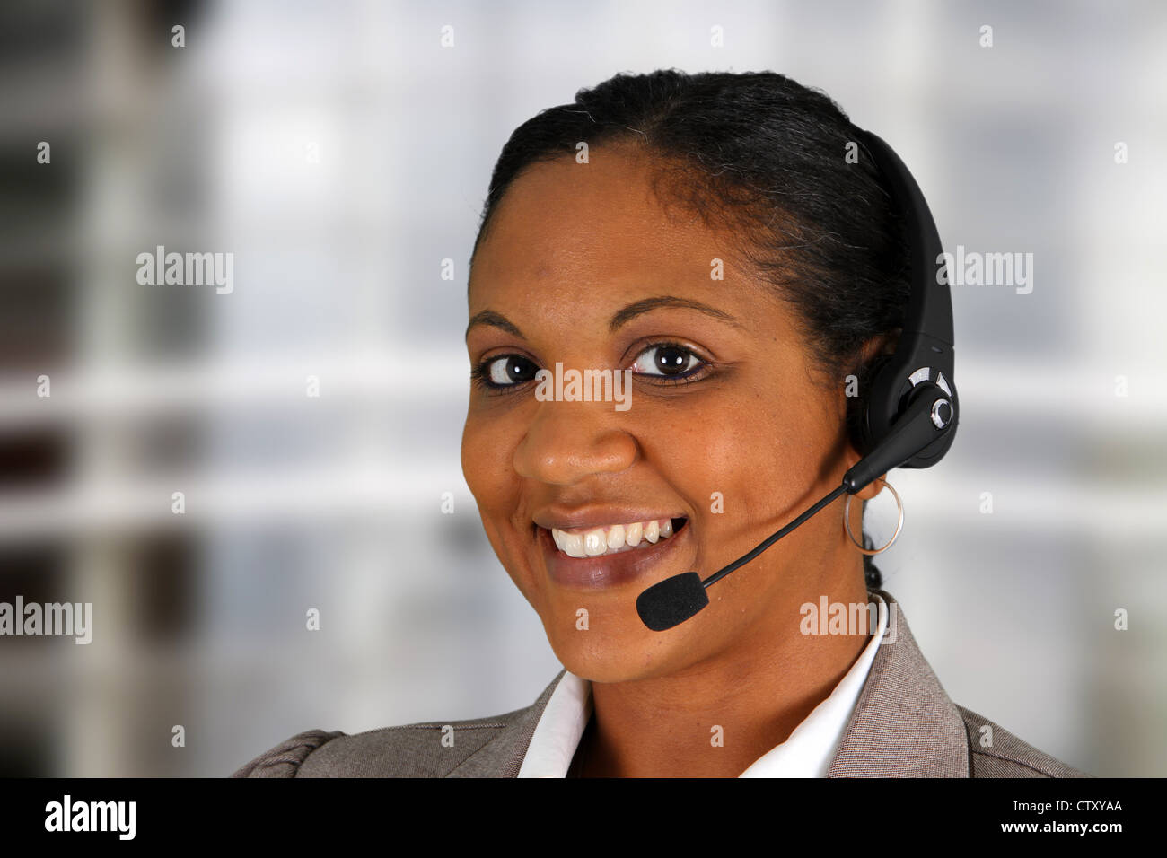 Young woman giving help as a customer service employee Stock Photo - Alamy