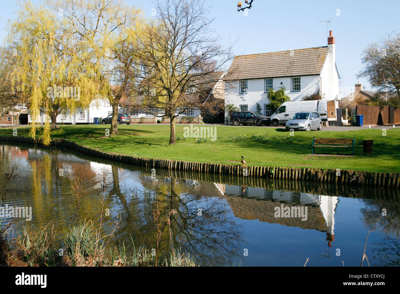 reflections in stream village green Histon Cambridgeshire England UK ...