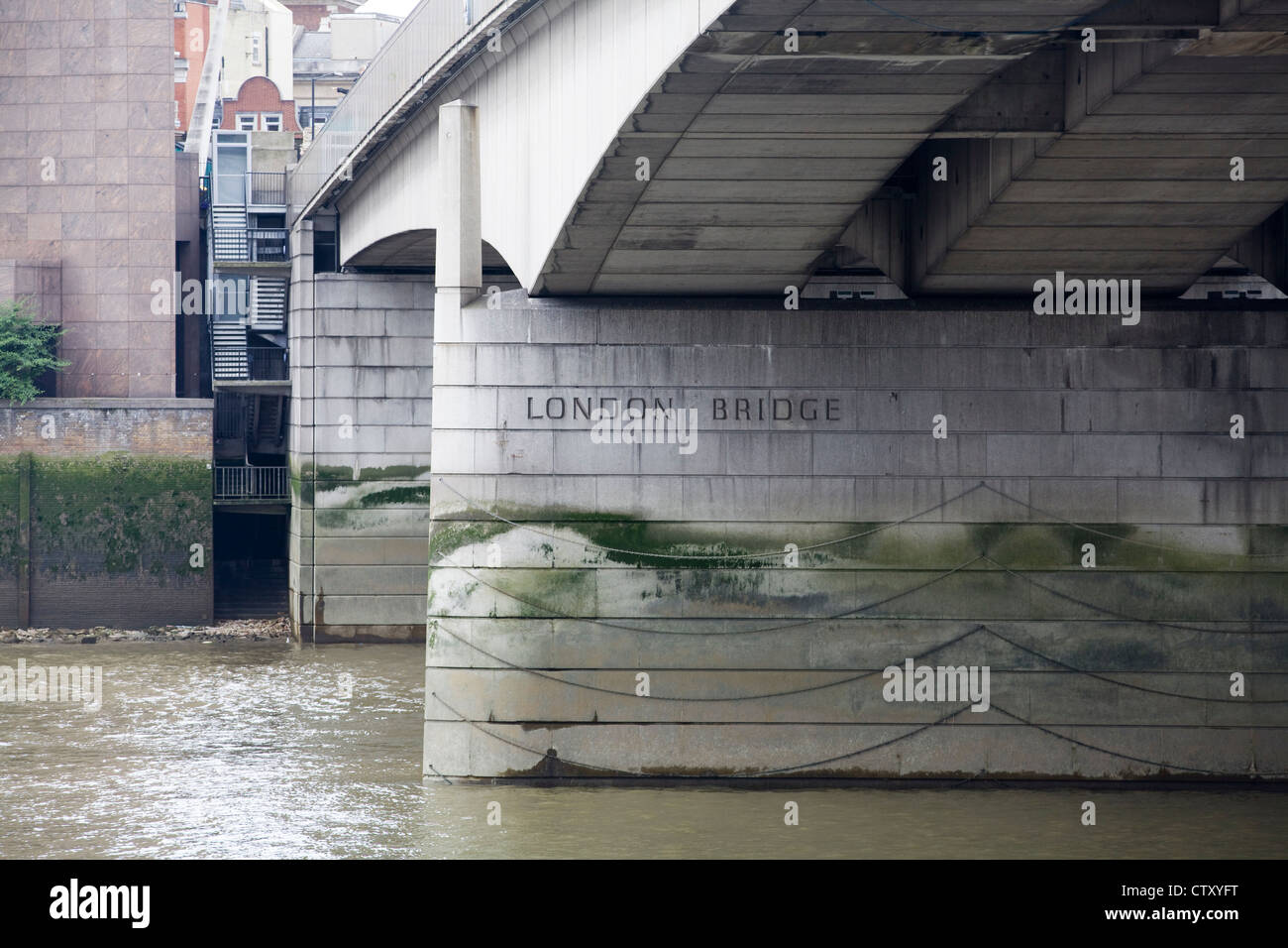 Underneath London Bridge by the Thames Stock Photo - Alamy