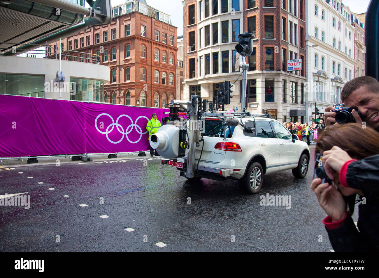 Hi-tech stabilised video camera equipment on road, women's marathon ...