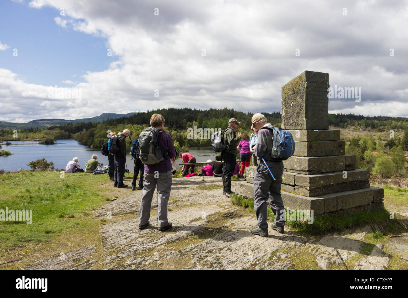 Ramblers group by monument above Llyn Elsi reservoir in Gwydyr Forest ...