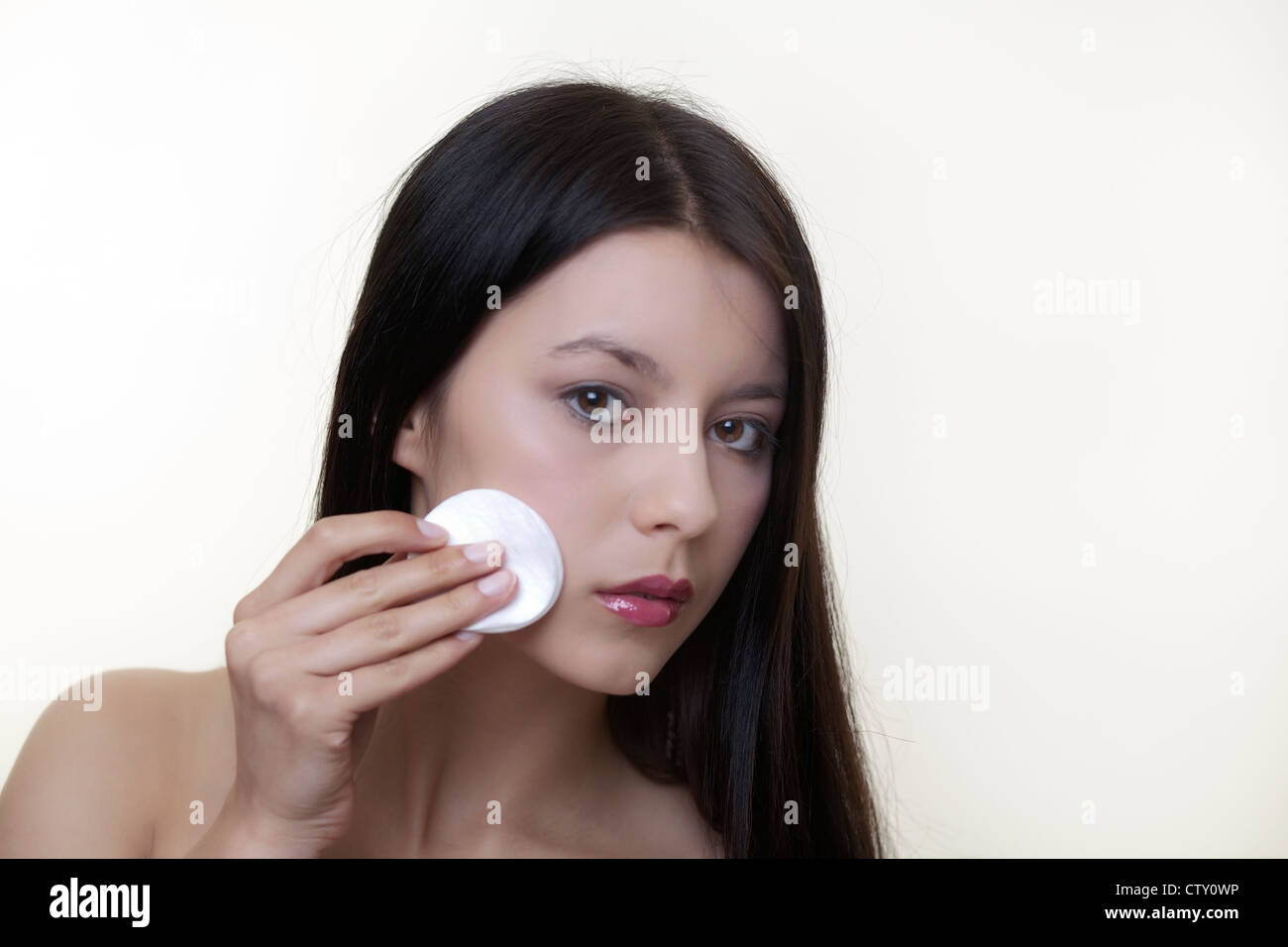 young girl wiping make up off her face Stock Photo - Alamy