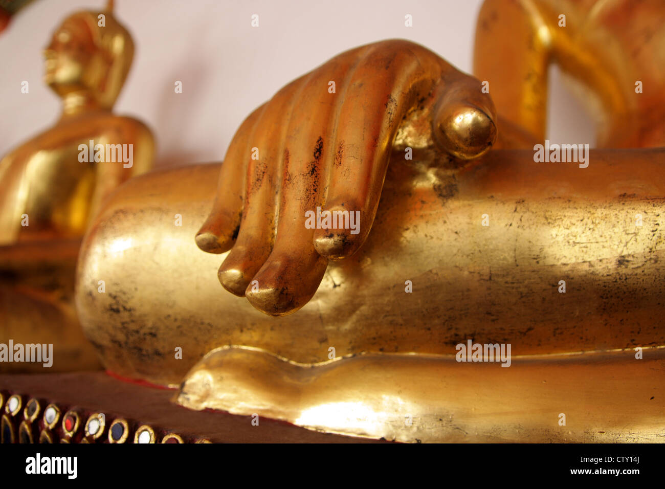 Hand of Golden Buddhist statue on leg Stock Photo - Alamy