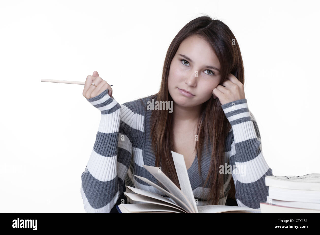 young woman working hard, looking at books and writing notes sitting at ...