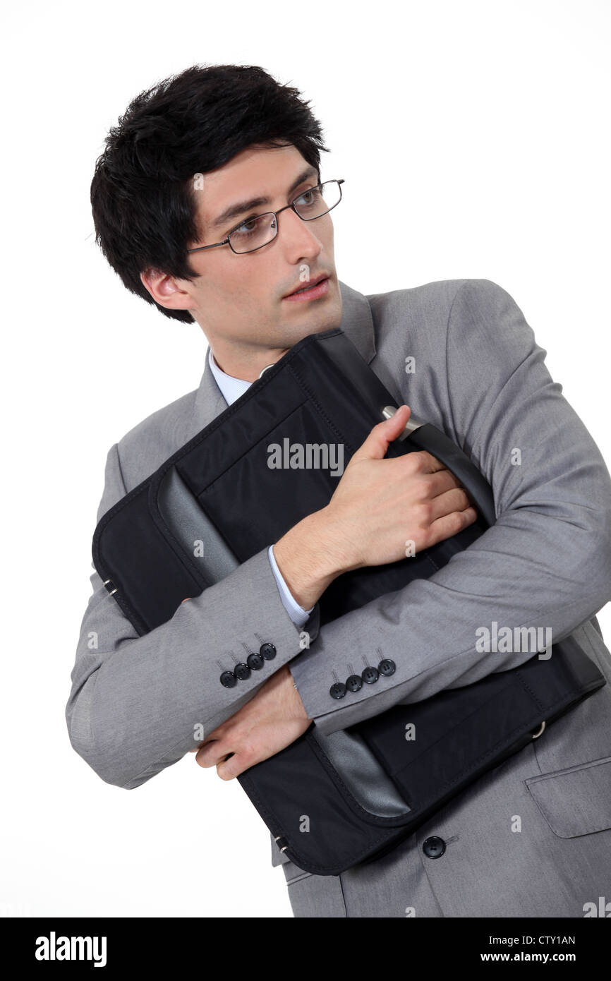 businessman holding tight his briefcase Stock Photo - Alamy