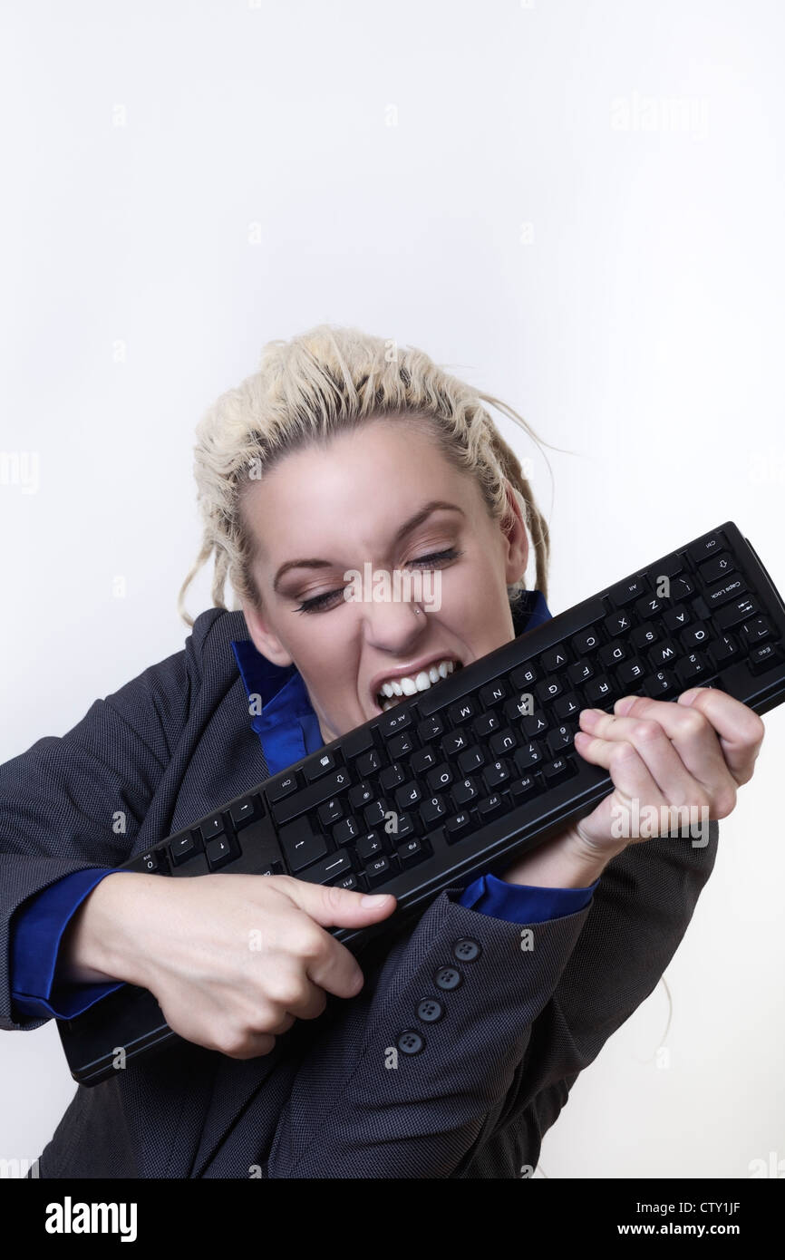 Business person with dreadlock hair biting on a computer keyboard Stock ...
