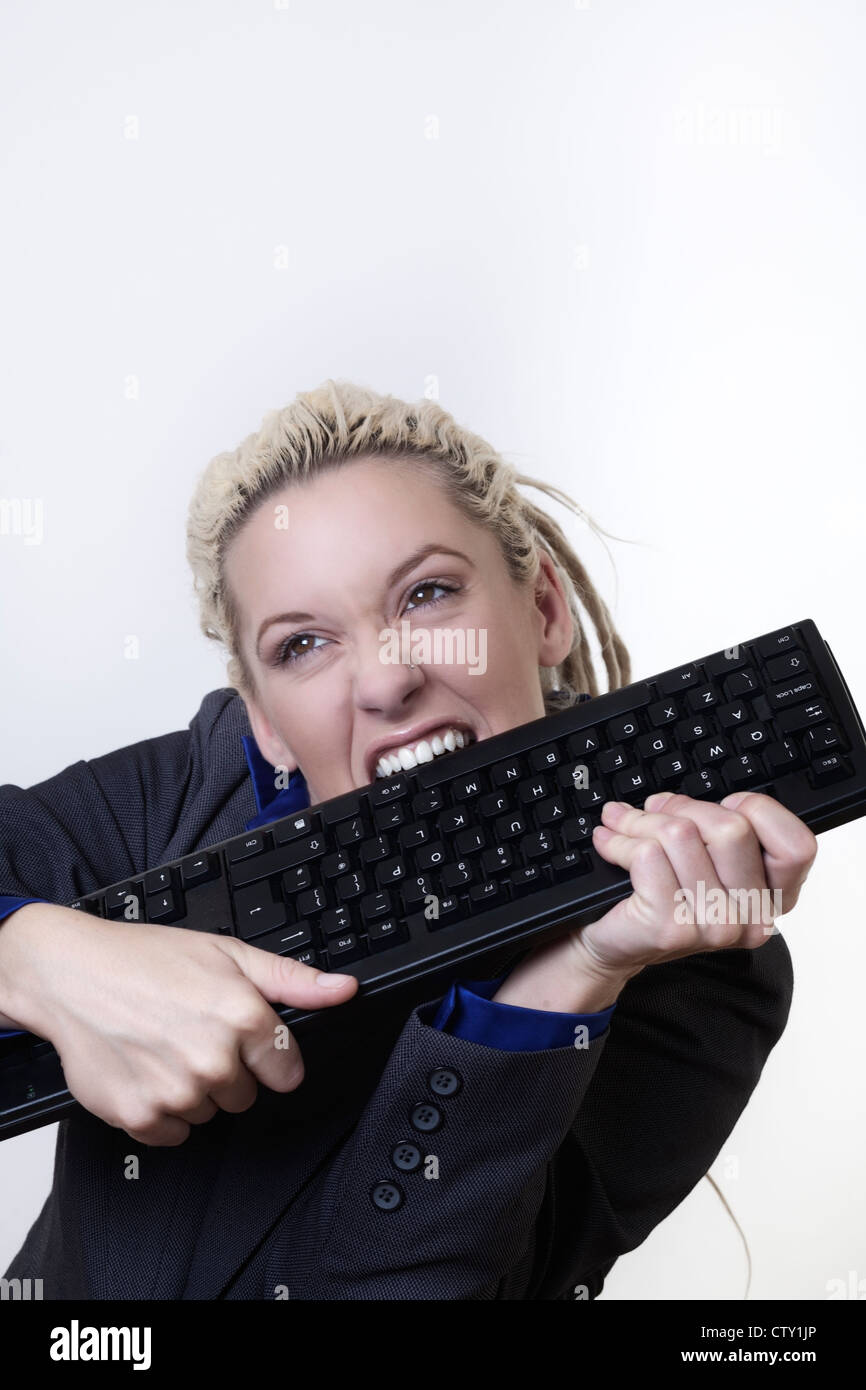 Business person with dreadlock hair biting on a computer keyboard Stock ...