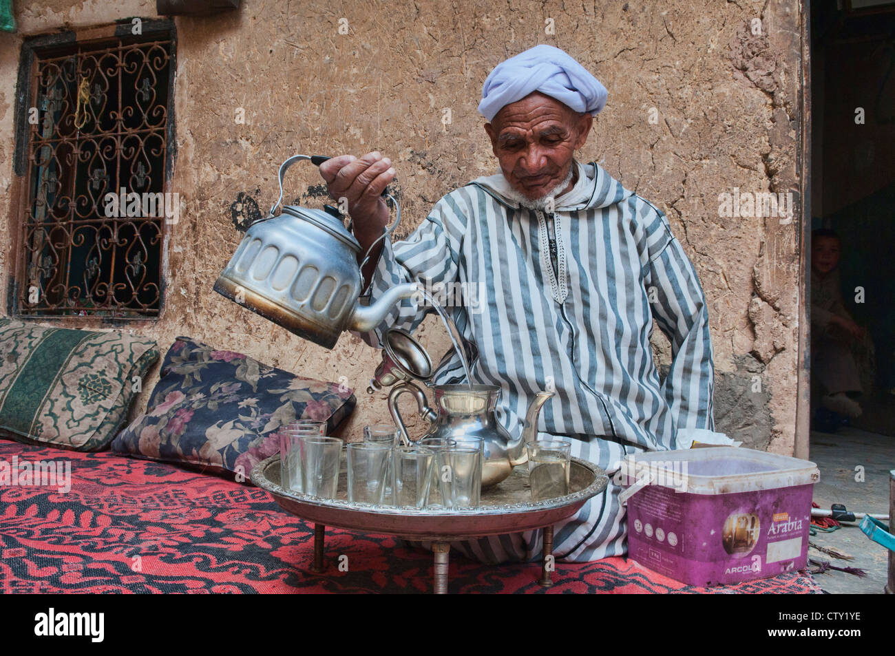 traditional Berber grandfather pouring tea in the Southern Atlas ...