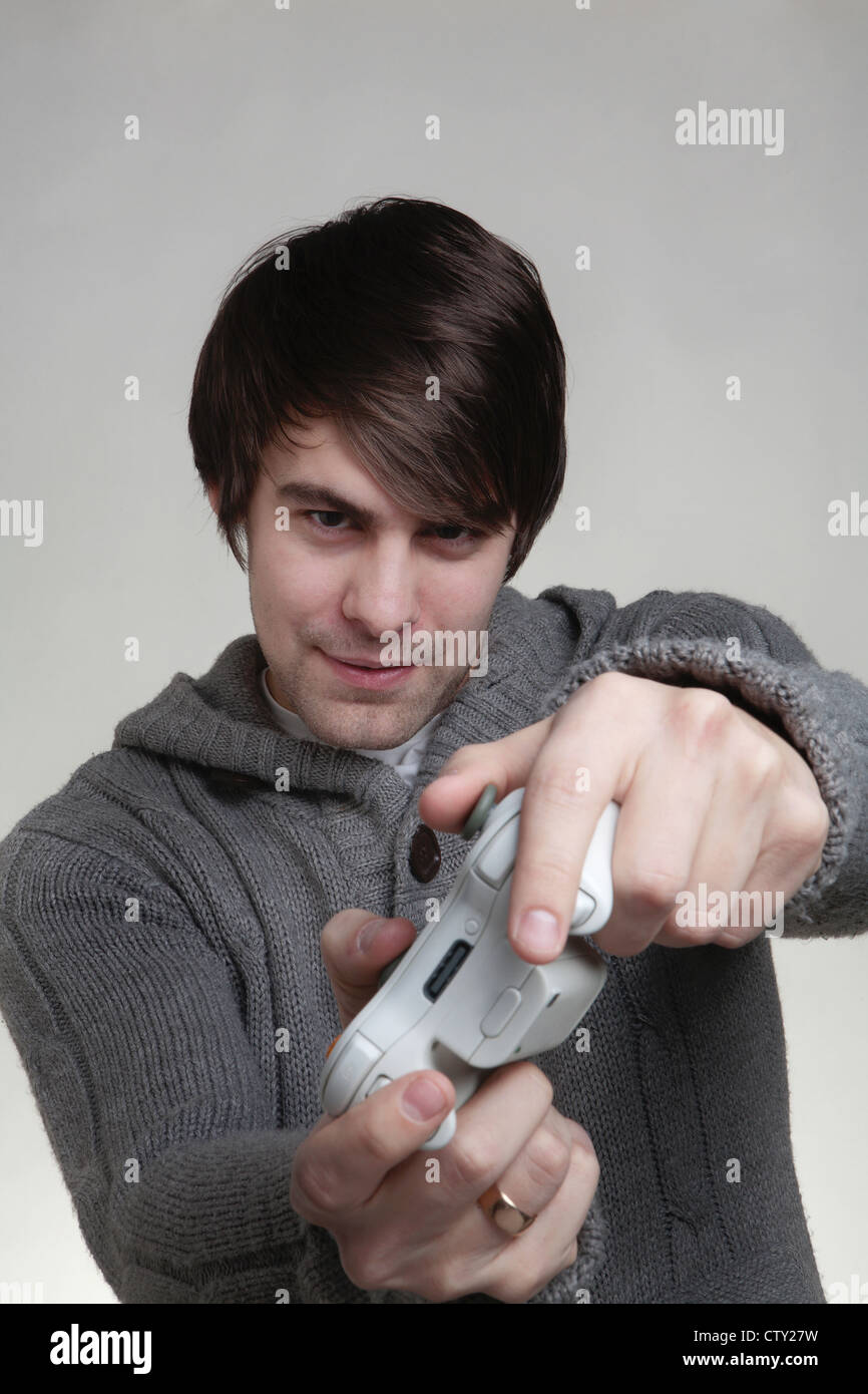 young guy playing a video game Stock Photo - Alamy