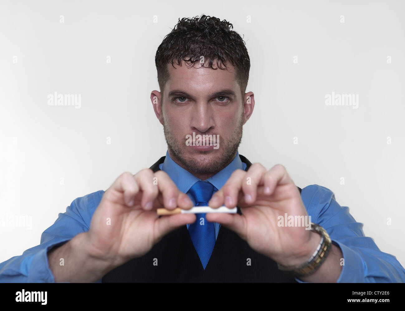 handsome man quitting smoking breaking his last cigarette Stock Photo ...