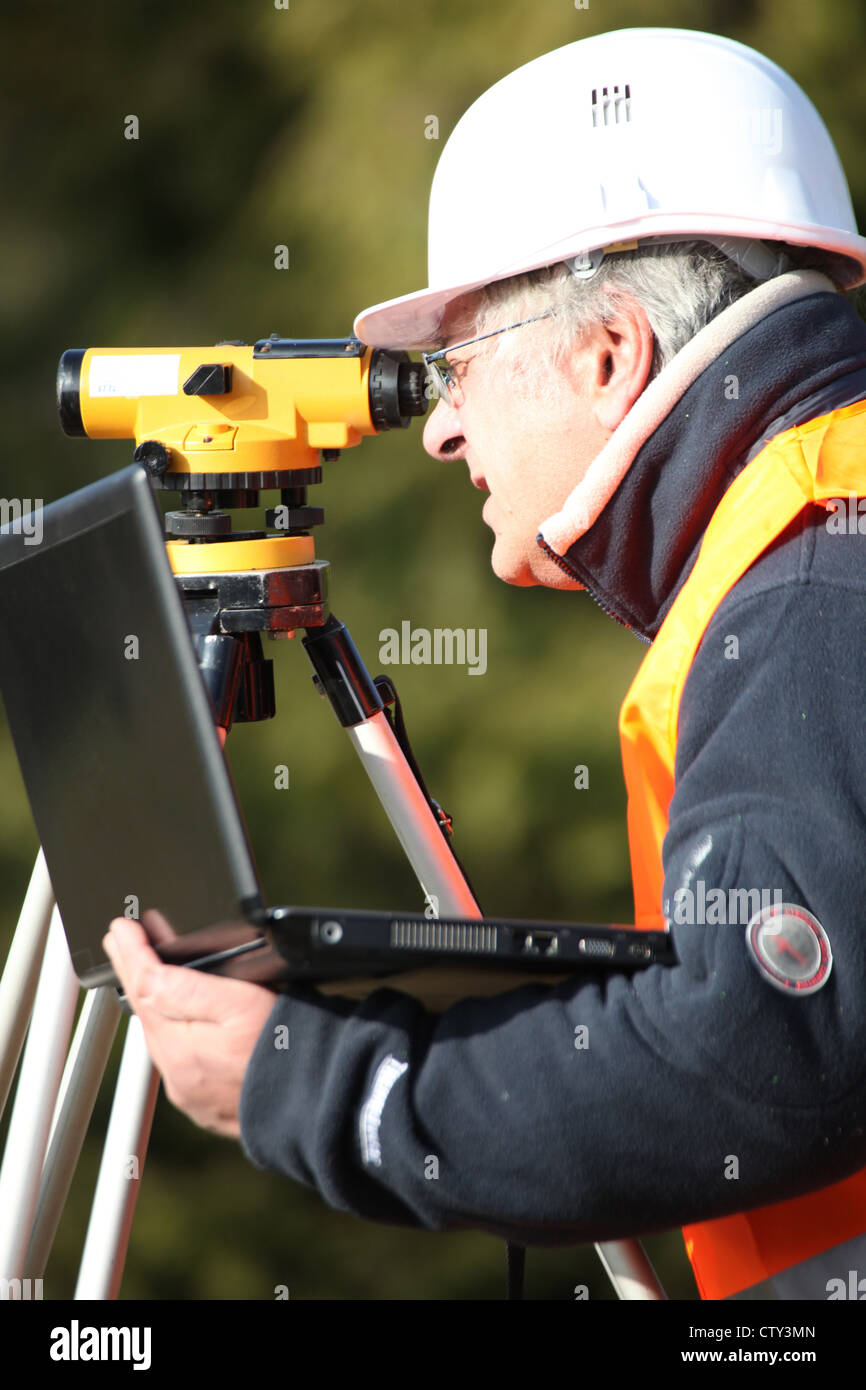 Man measuring ground Stock Photo - Alamy