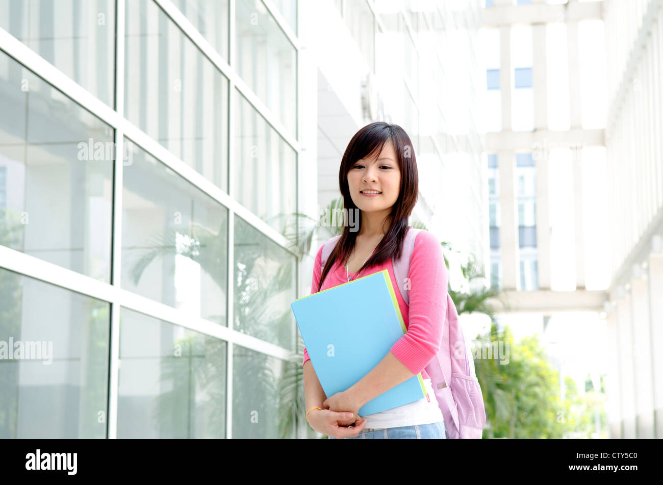 College Student standing outside college building Stock Photo - Alamy