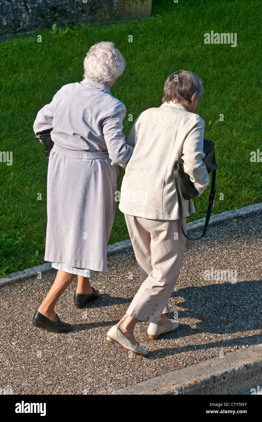 Overhead view of two women walking along pavement - France Stock Photo ...