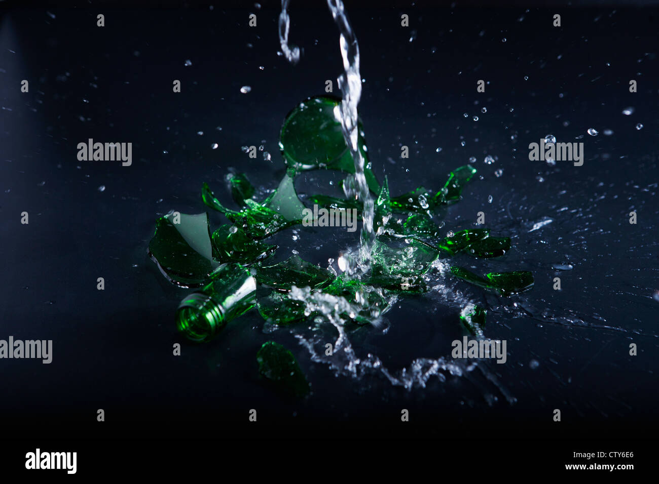 Pouring water onto the broken glass bottle Stock Photo - Alamy