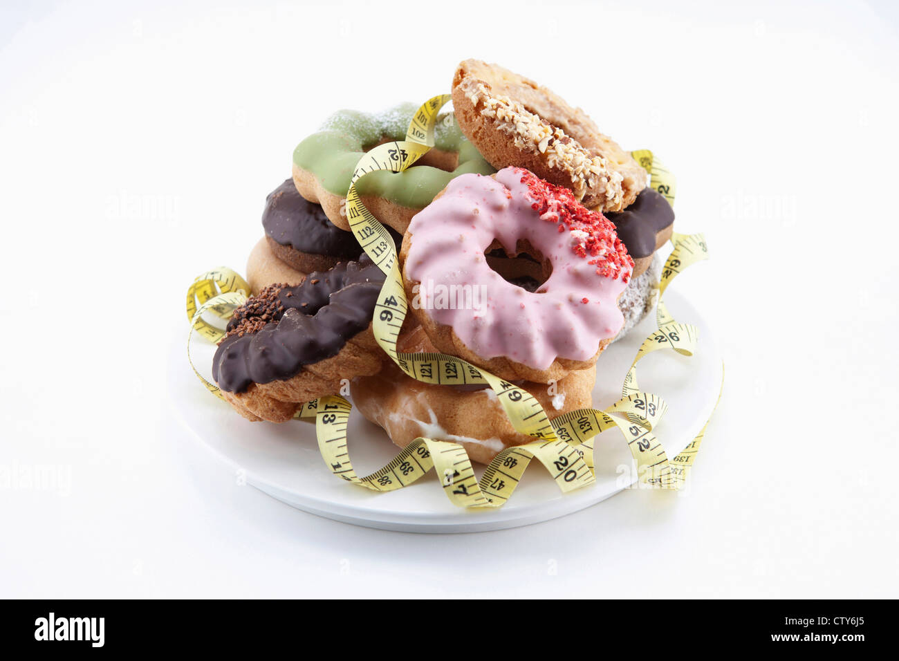 A measuring tape and donut on the dish Stock Photo - Alamy
