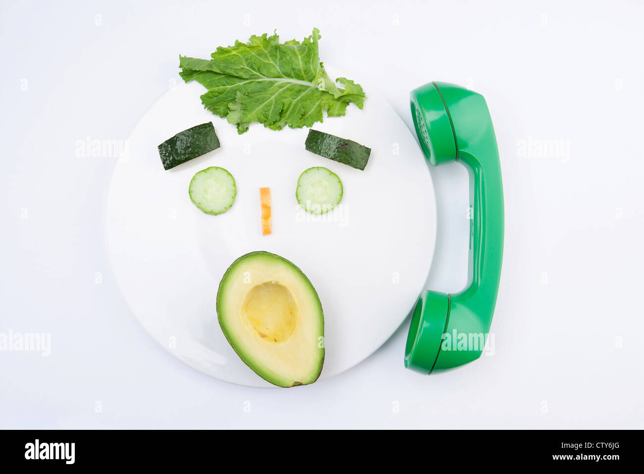 Green face of vegetable answering the phone Stock Photo - Alamy