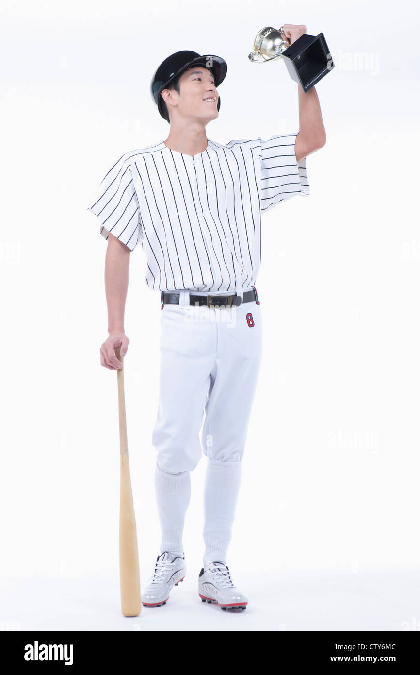 A baseball player with gold trophy Stock Photo - Alamy