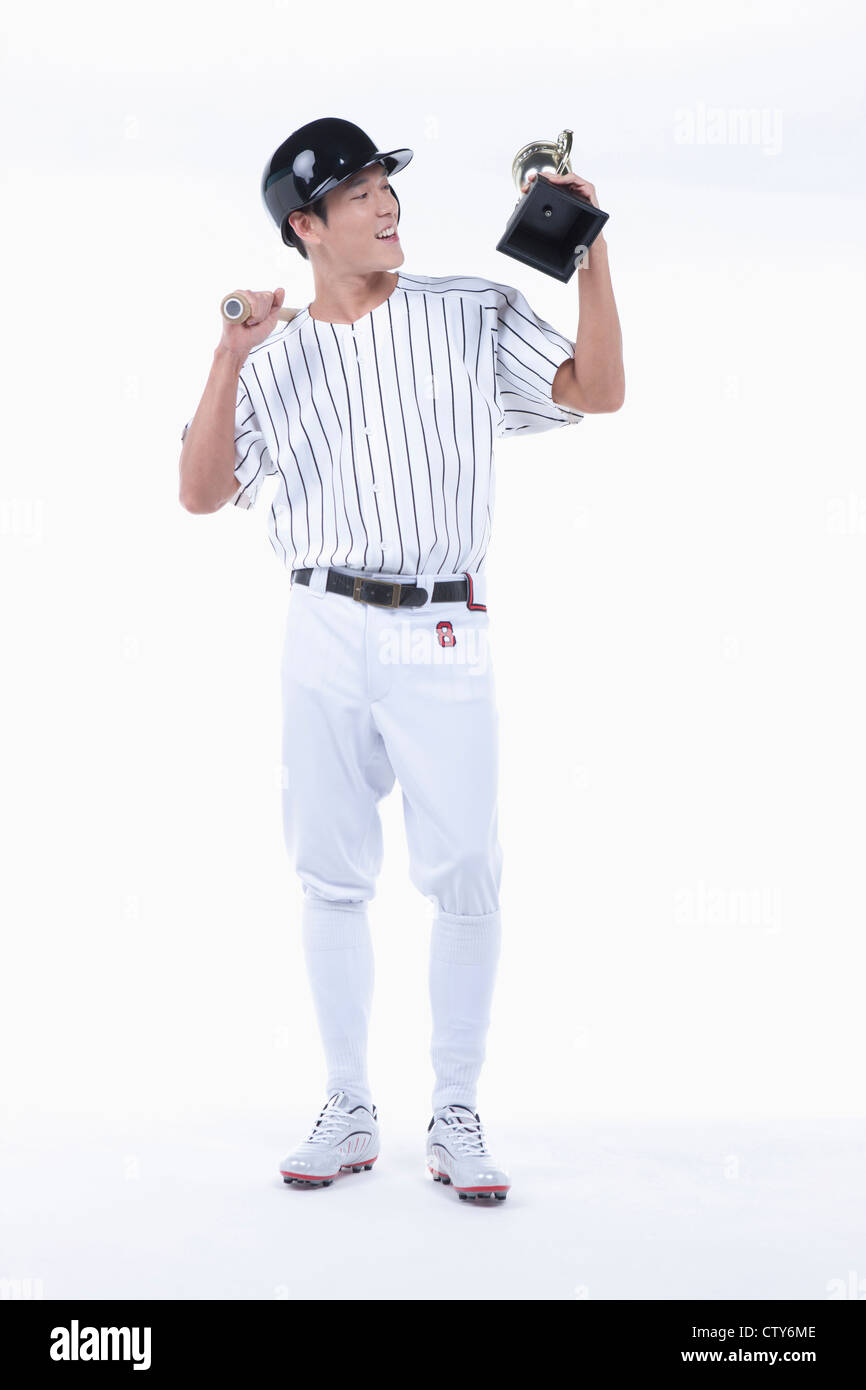 A baseball player with gold trophy Stock Photo - Alamy