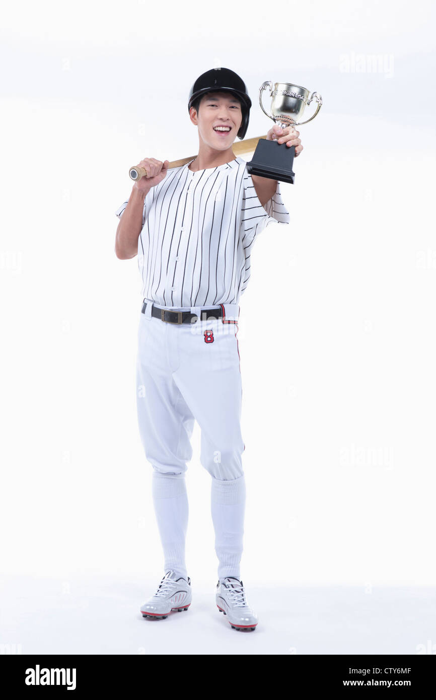 A baseball player with gold trophy Stock Photo - Alamy
