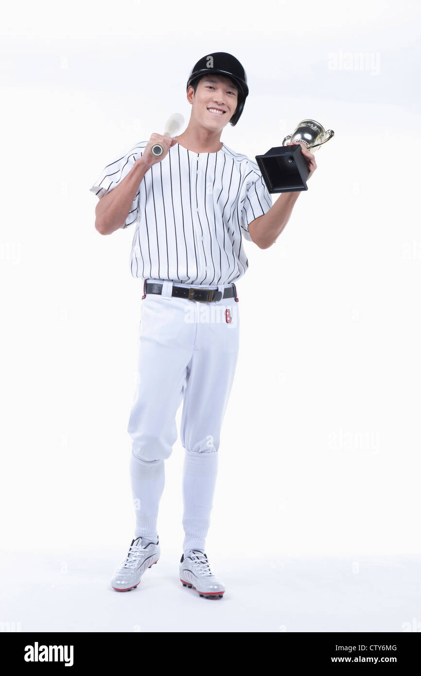 A baseball player with gold trophy Stock Photo - Alamy
