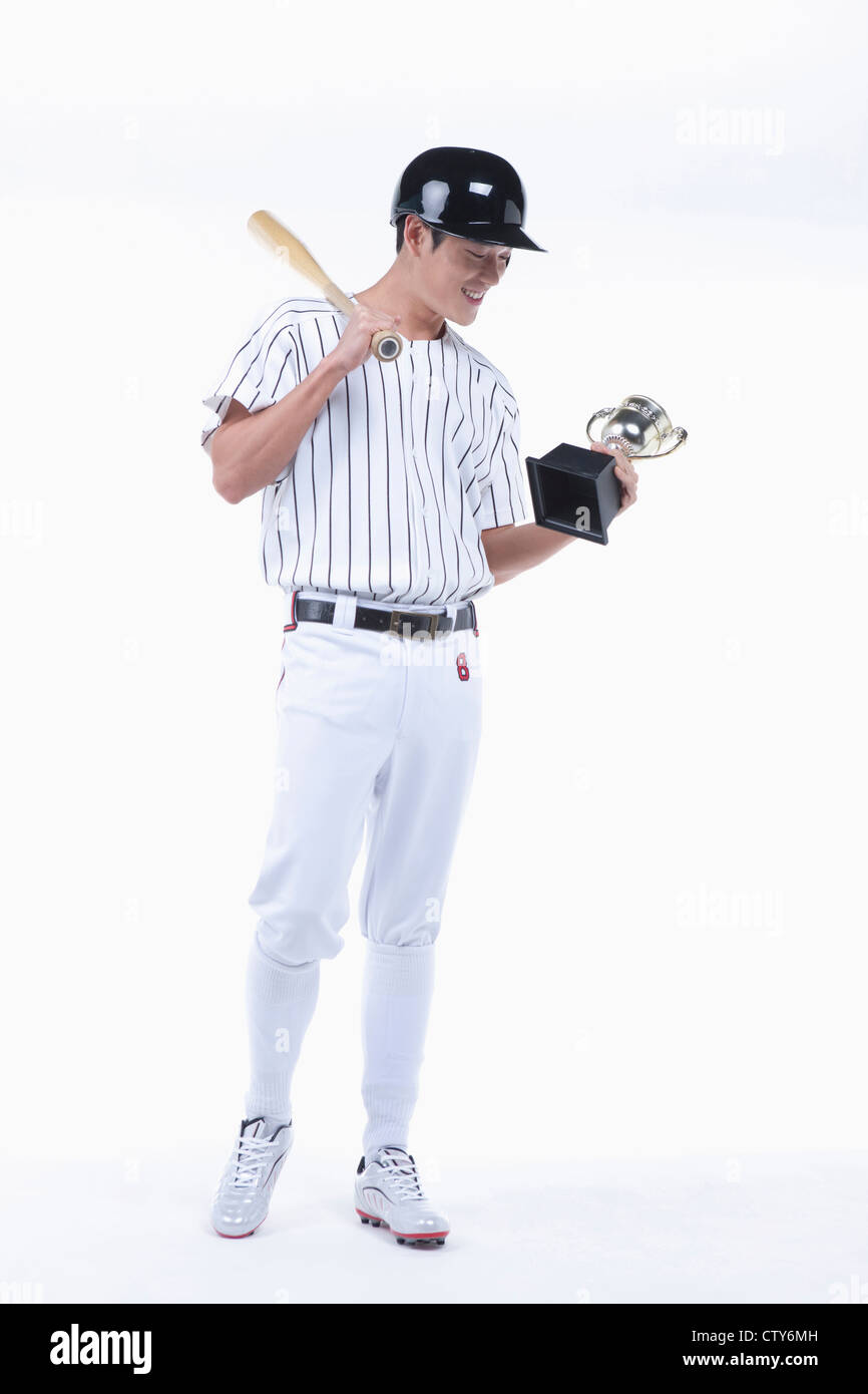 A baseball player with gold trophy Stock Photo - Alamy