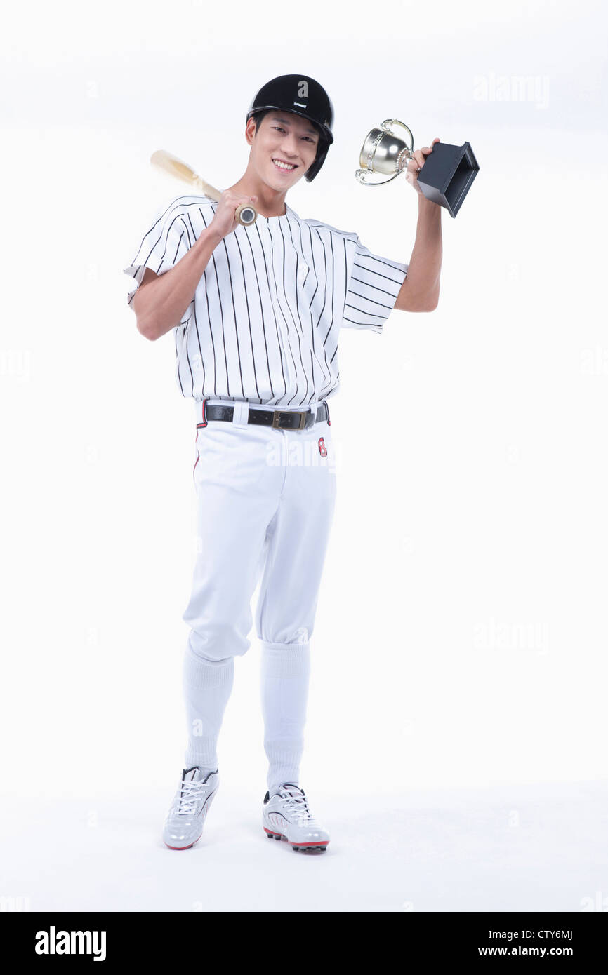 A baseball player with gold trophy Stock Photo - Alamy