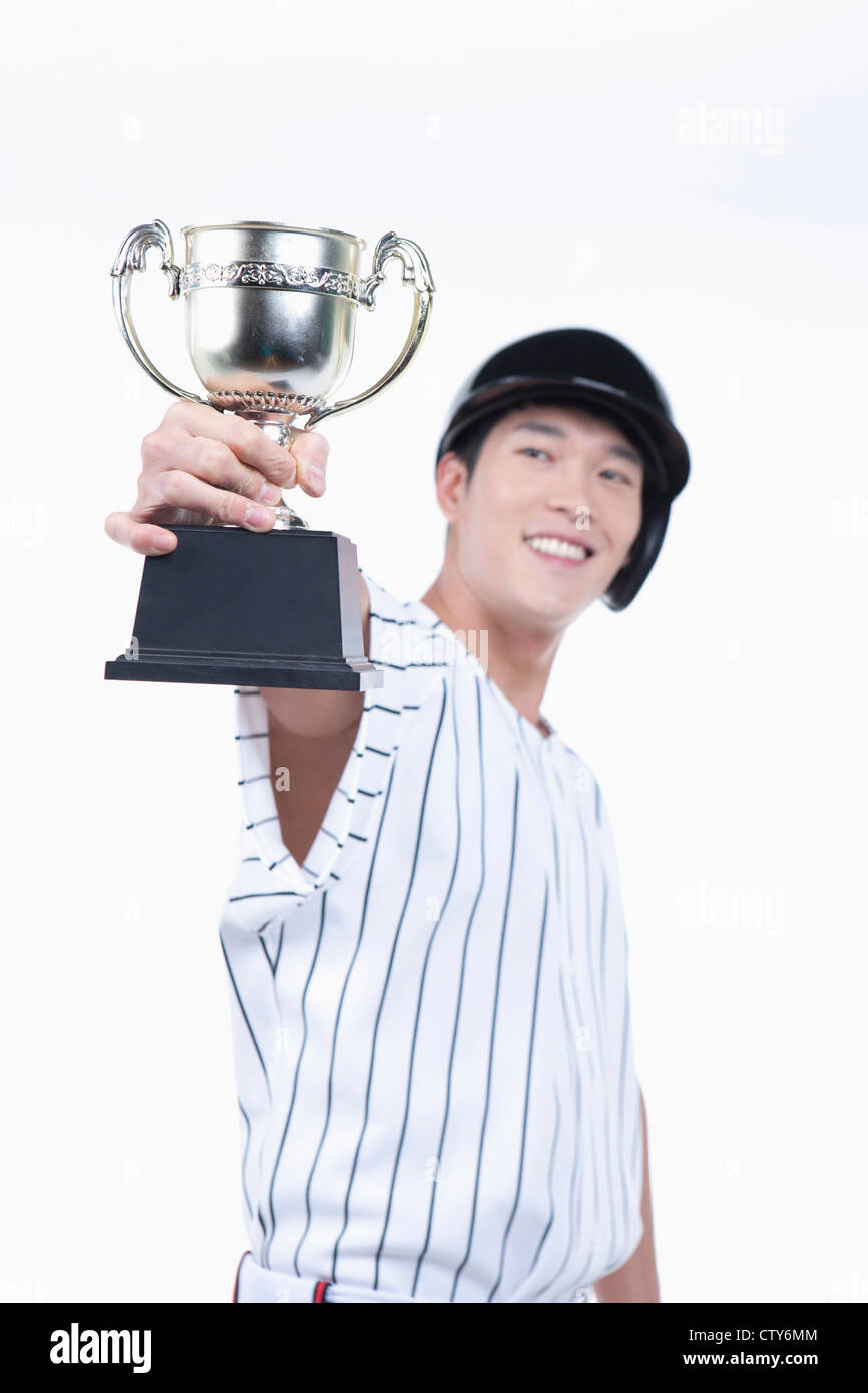 A baseball player with gold trophy Stock Photo - Alamy
