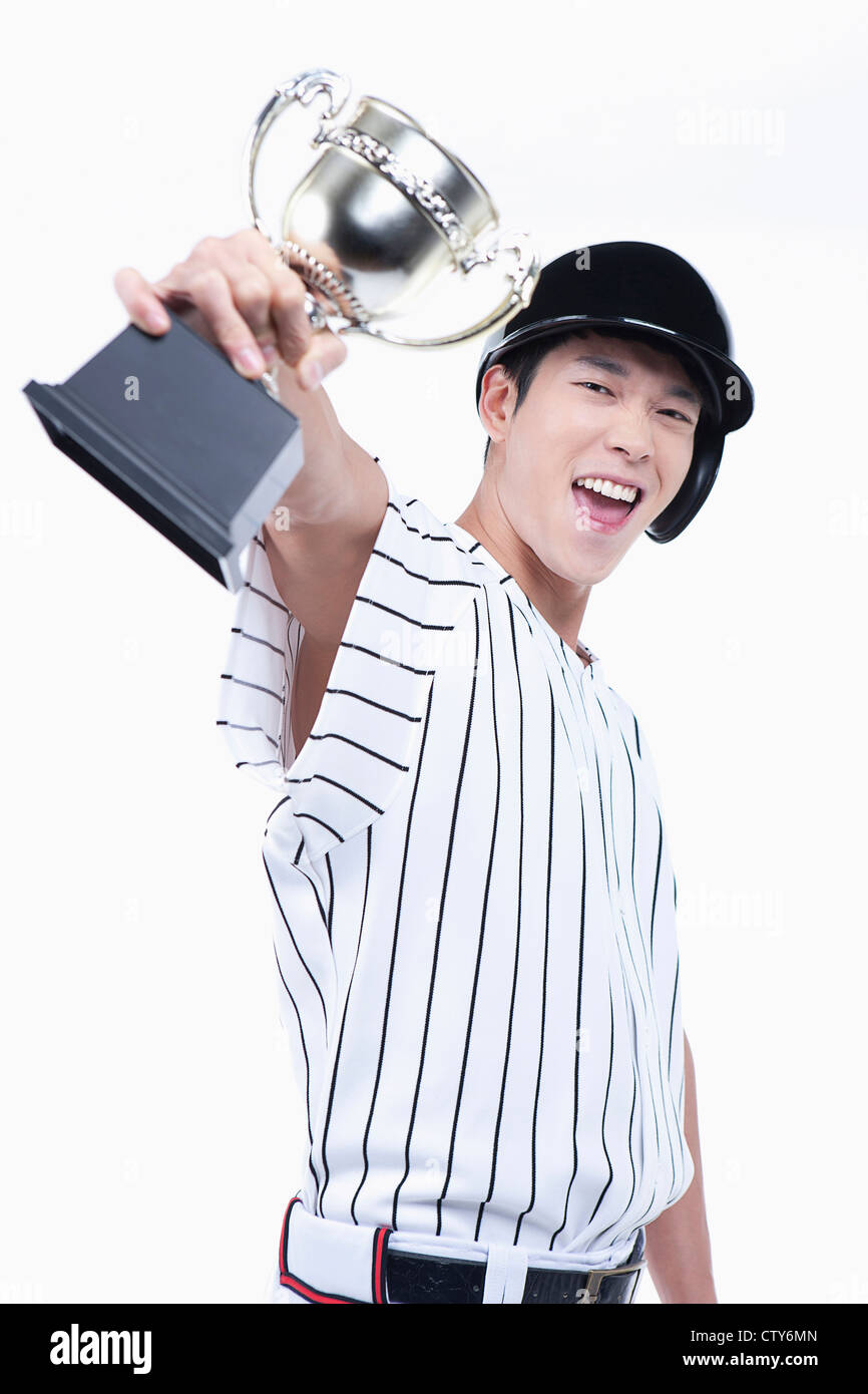 A baseball player with gold trophy Stock Photo - Alamy