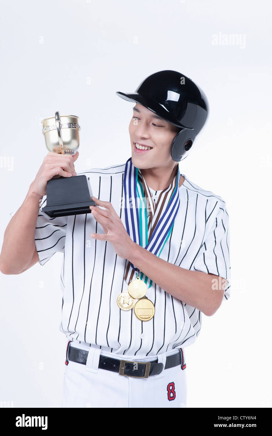 A baseball player with gold medals and trophy Stock Photo - Alamy