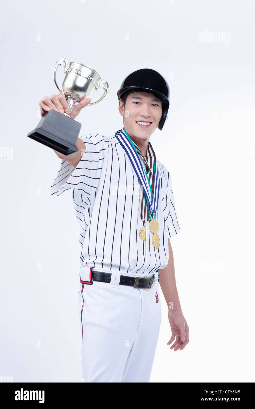 A baseball player with gold medals and trophy Stock Photo - Alamy