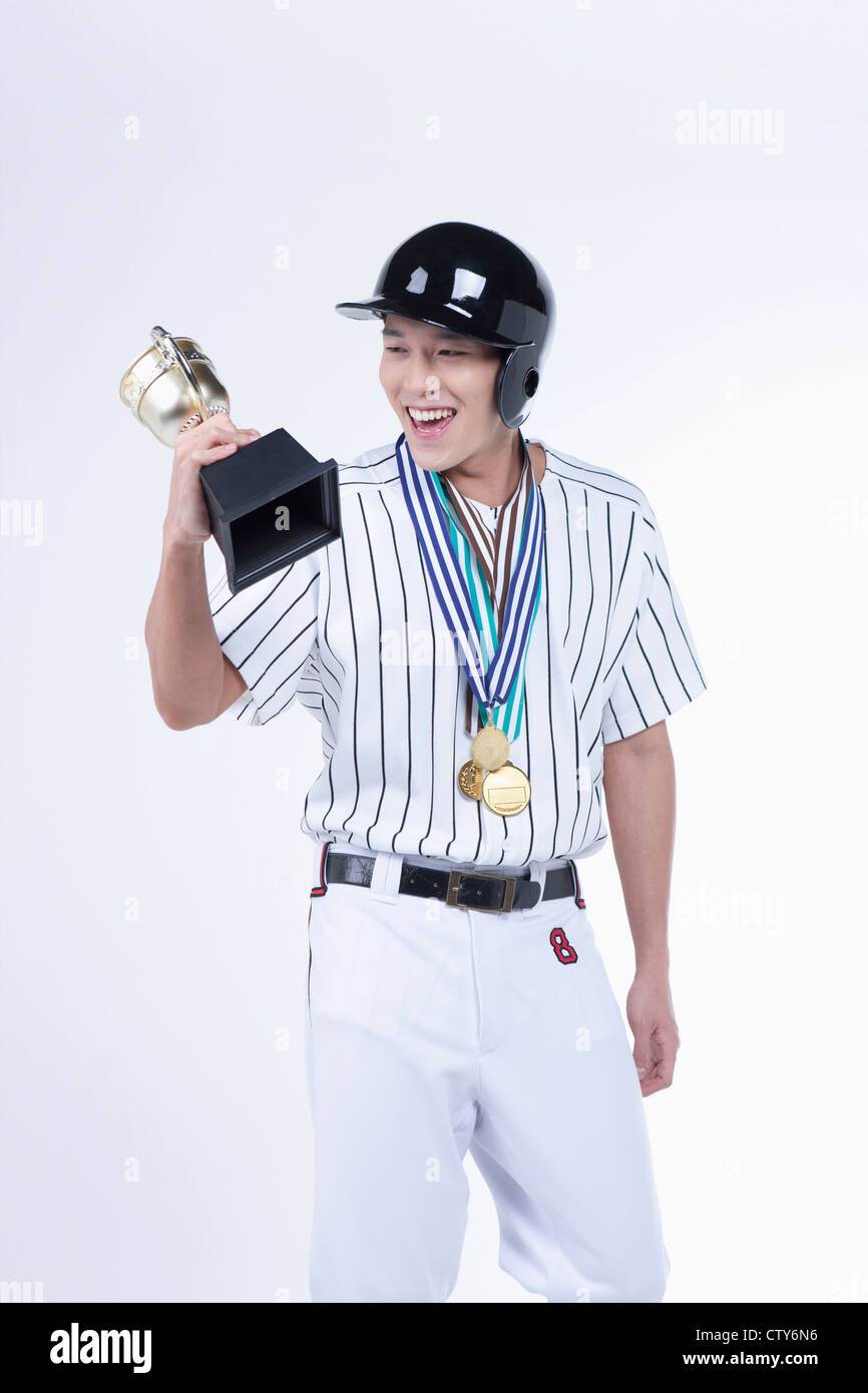 A baseball player with gold medals and trophy Stock Photo - Alamy