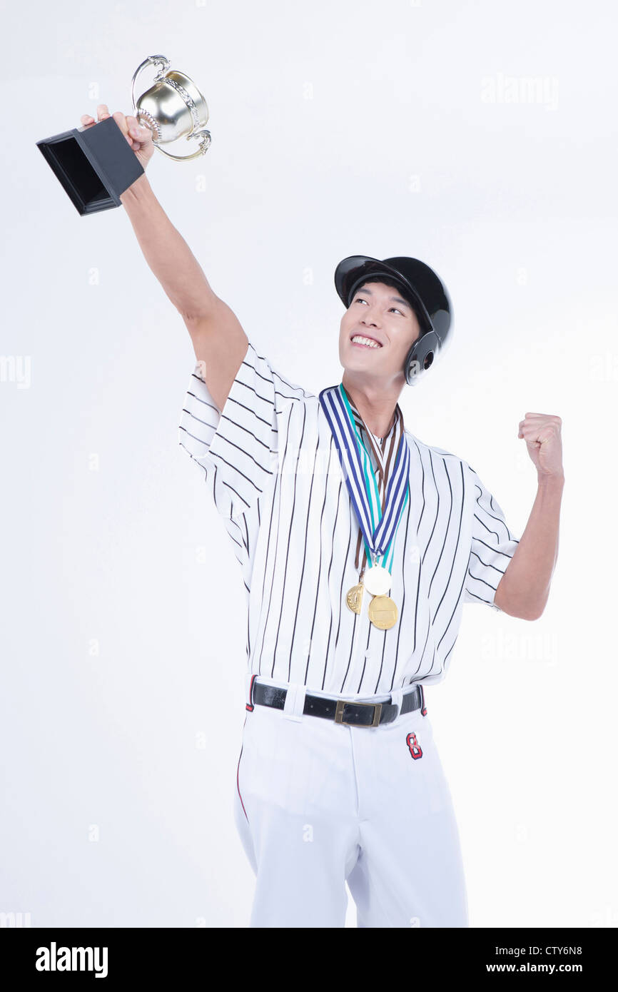 A baseball player with gold medals and trophy Stock Photo - Alamy