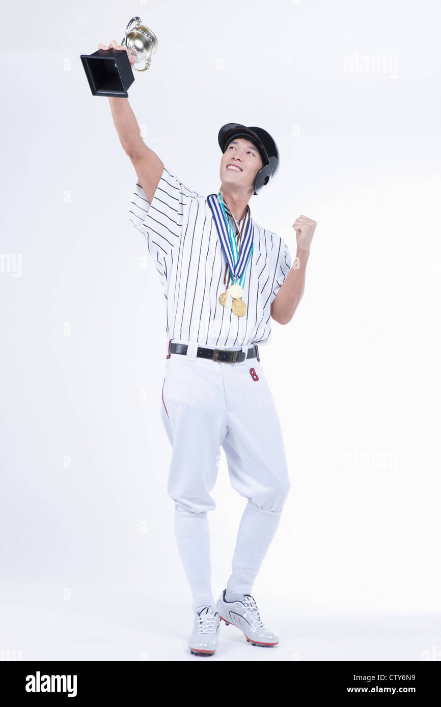 A baseball player with gold medals and trophy Stock Photo - Alamy