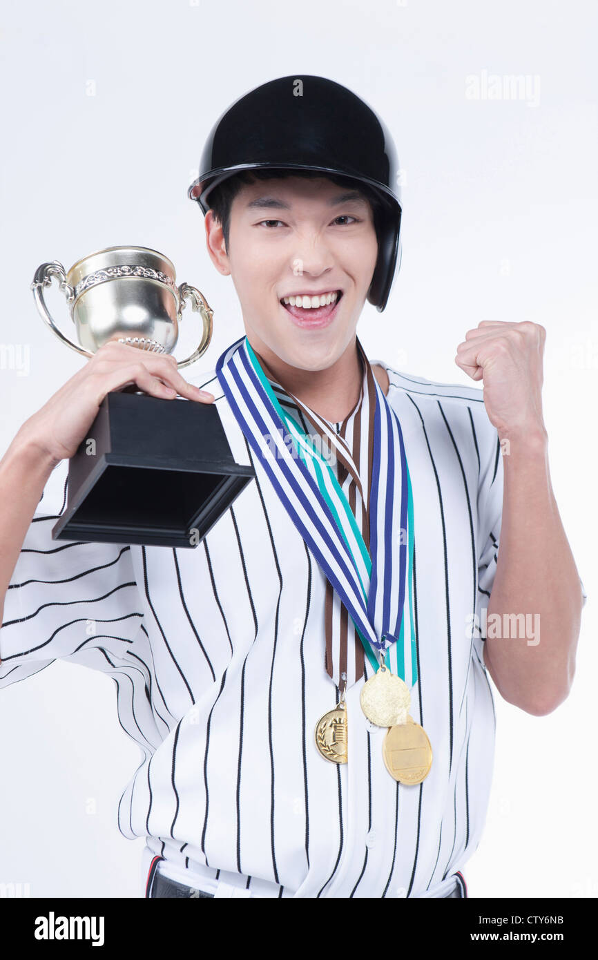 A baseball player with gold medals and trophy Stock Photo - Alamy