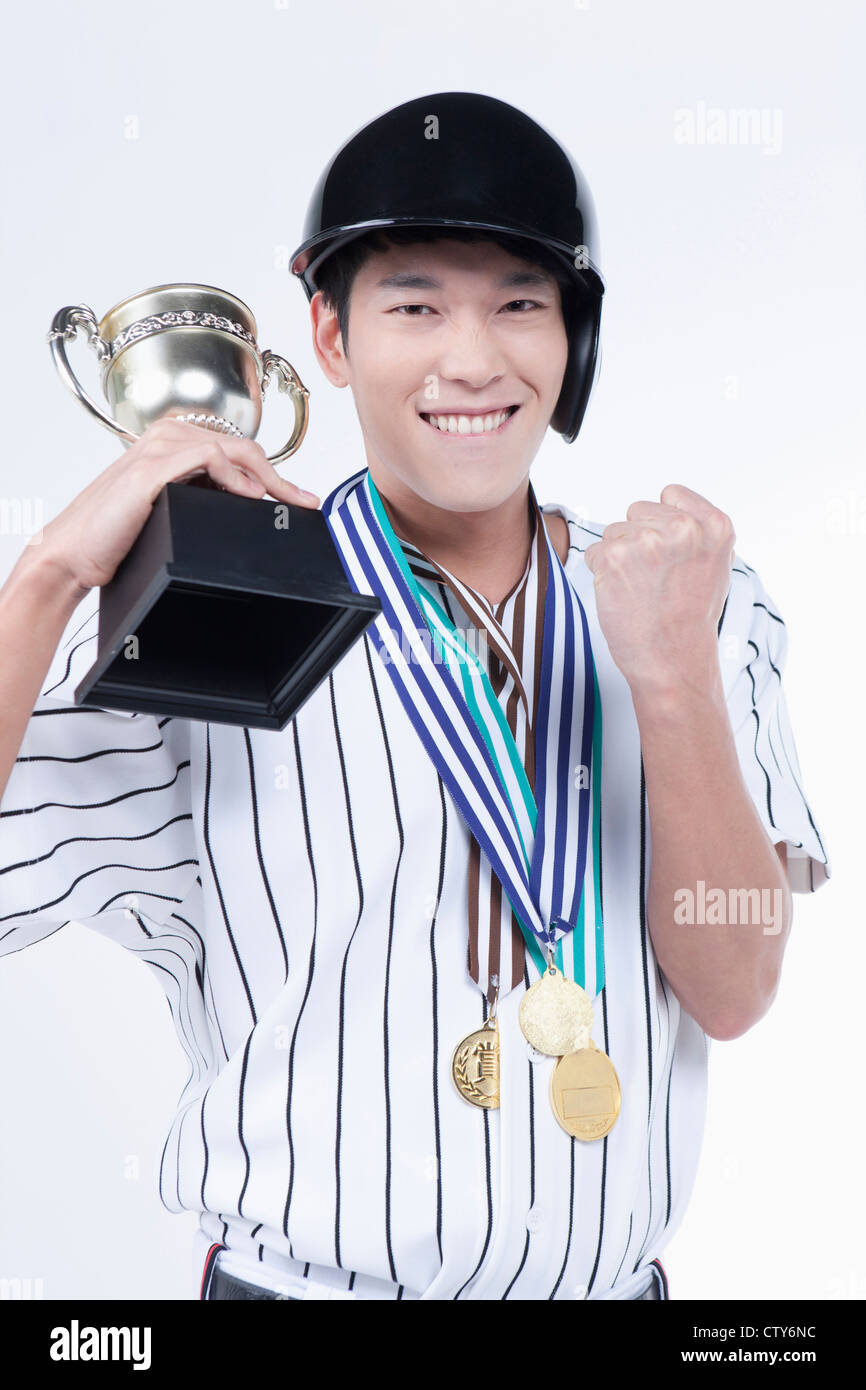 A baseball player with gold medals and trophy Stock Photo - Alamy