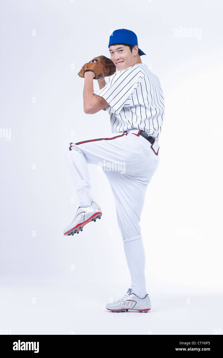 A baseball player pitching a ball Stock Photo - Alamy