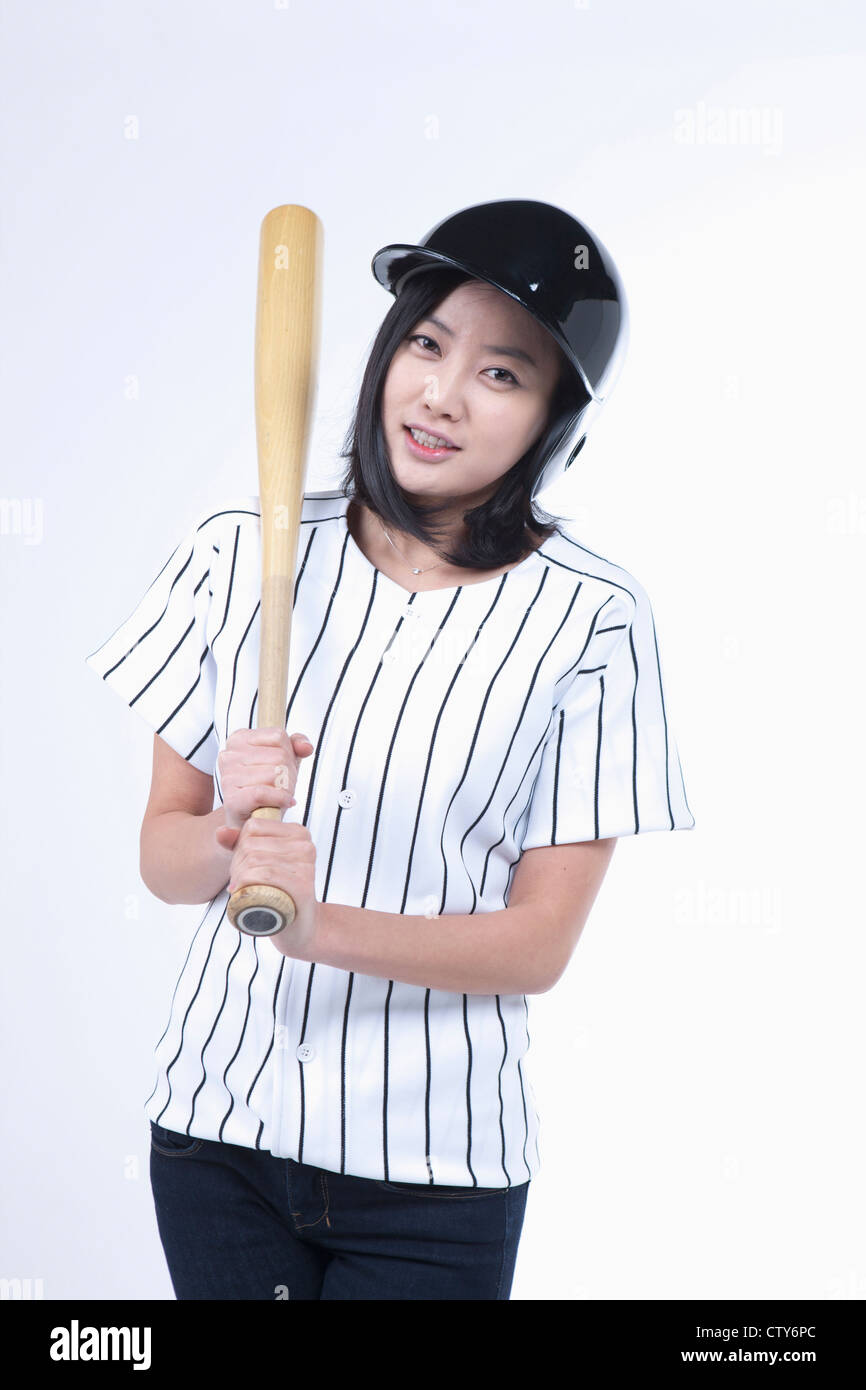A female baseball player with a bat Stock Photo - Alamy