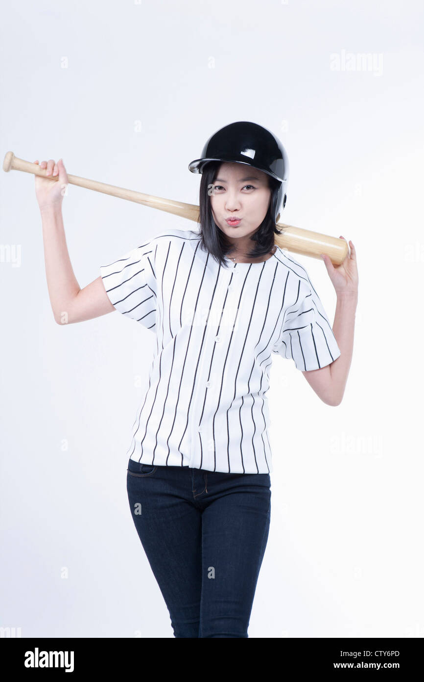 A female baseball player with a bat Stock Photo - Alamy