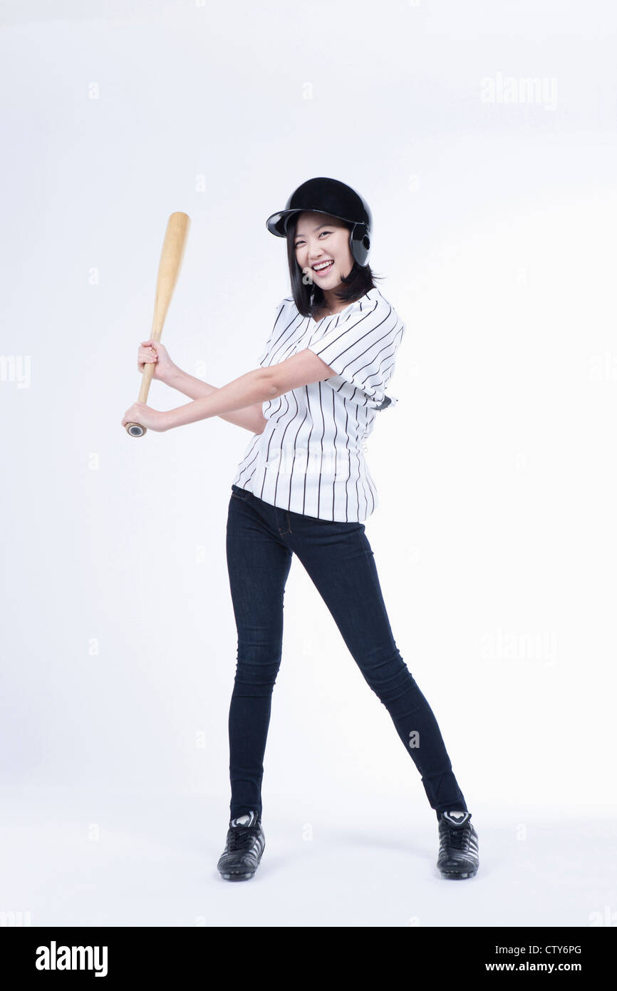 A female baseball player with a bat Stock Photo - Alamy